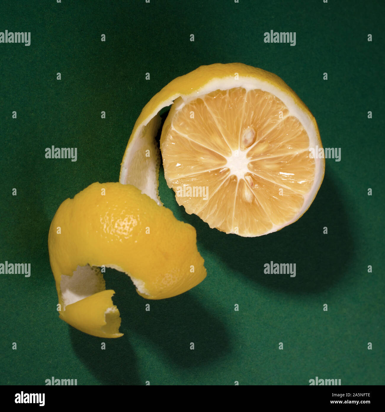Fresh juicy lemon with shadow on a green background. Minimalist poster ...
