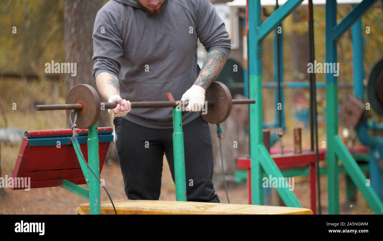 Man bodybuilder pulls up dumbbells hi-res stock photography and images ...