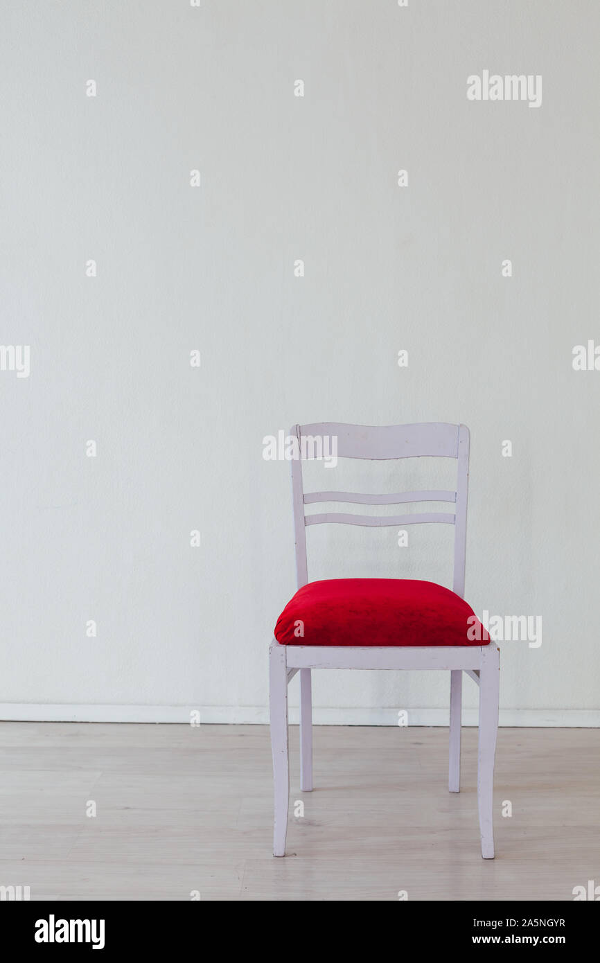 one chair in the interior of a white empty room Stock Photo - Alamy