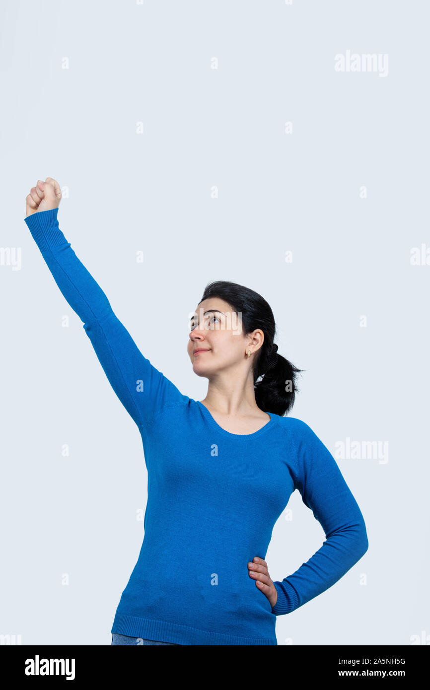 Strong, determined, confident woman with her fist raising showing power ...