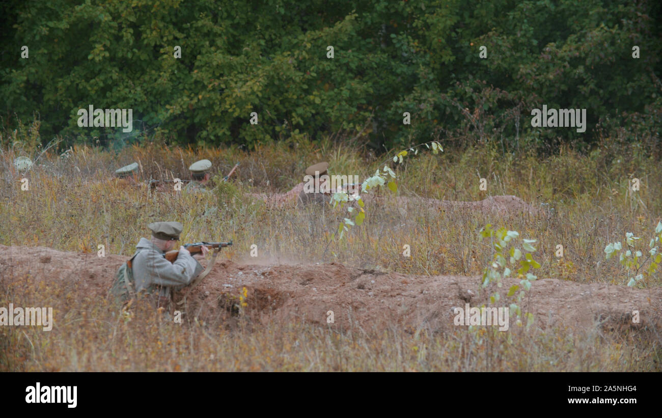 Military men in a trench are shooting. Mid shot Stock Photo - Alamy