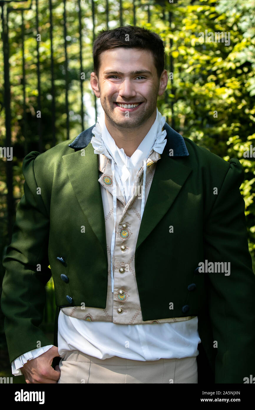 Portrait of attractive gentleman dressed in vintage costume standing in ...