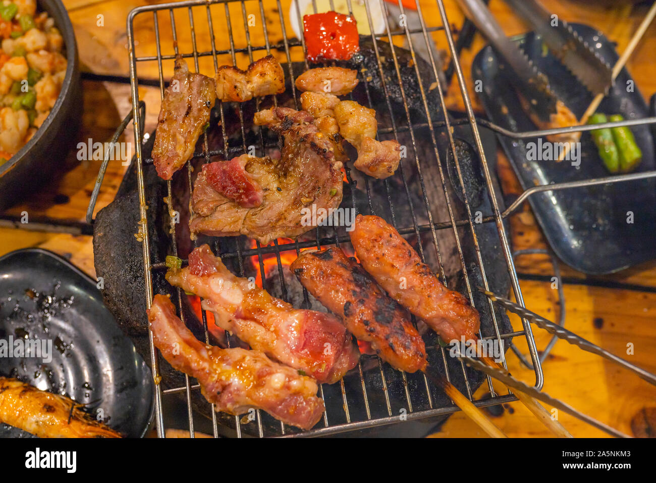 Top view photo of meats and skewers on barbecue stove Stock Photo - Alamy