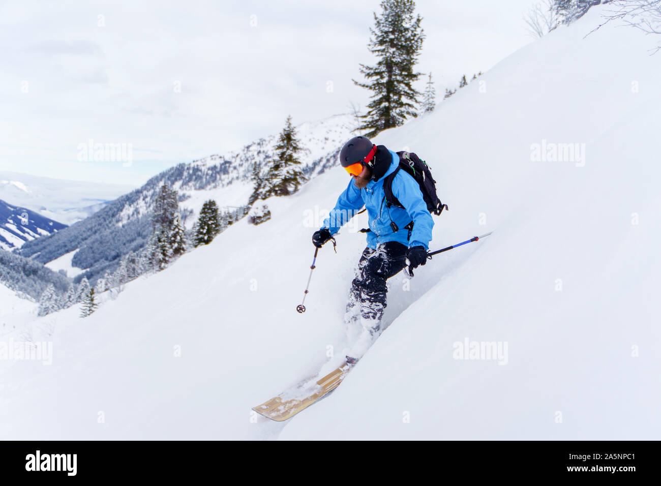 Image of athlete man with beard skiing in winter resort from snowy ...