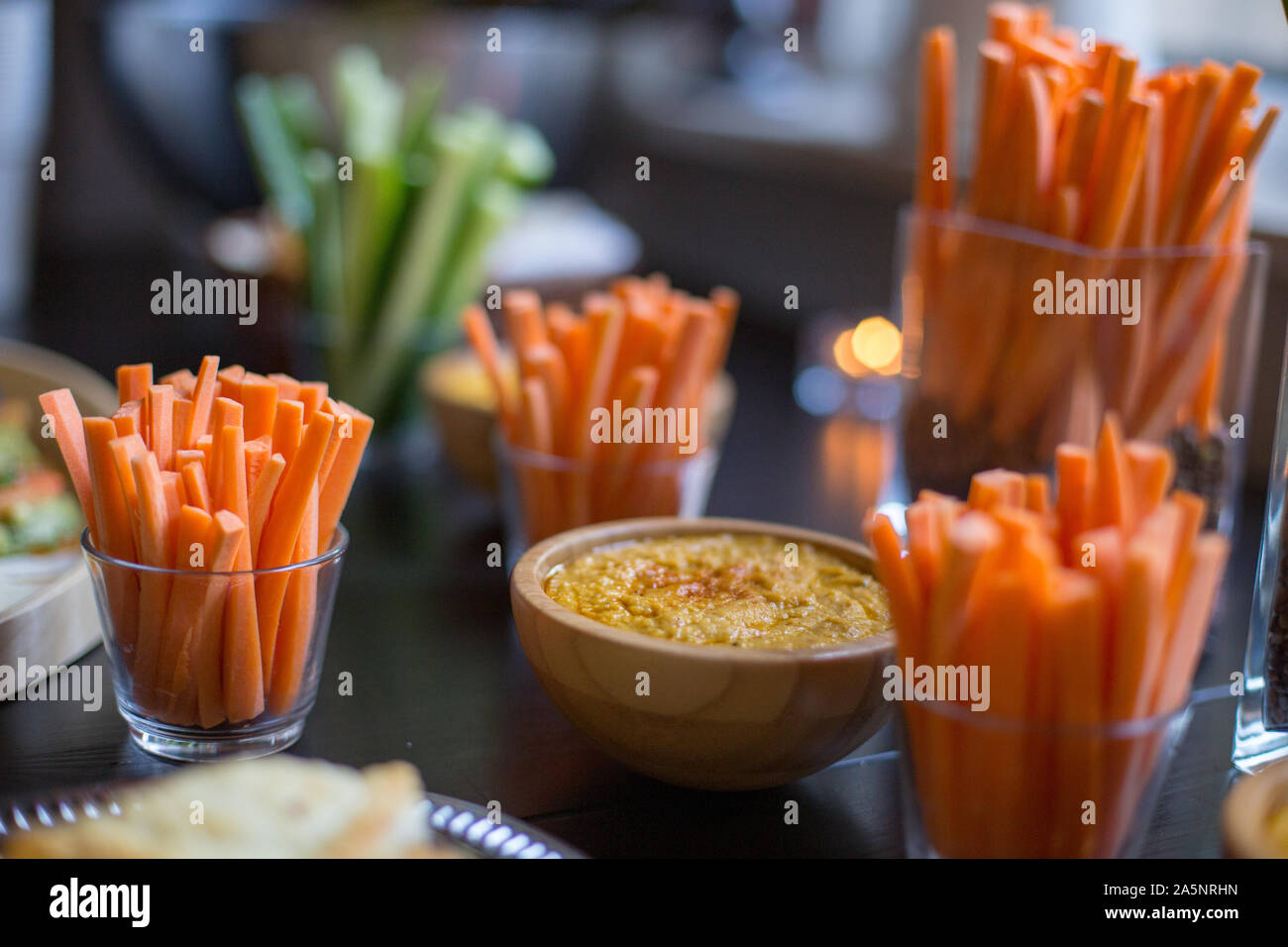 Carrot and cucumber sticks ready for dipping in hummus bowl Stock Photo ...