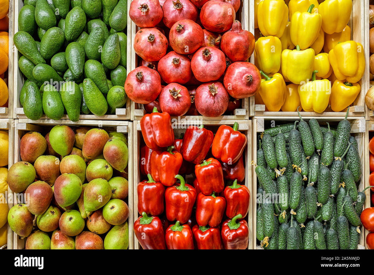 A counter with different vegetables in drawers is beautifully and ...