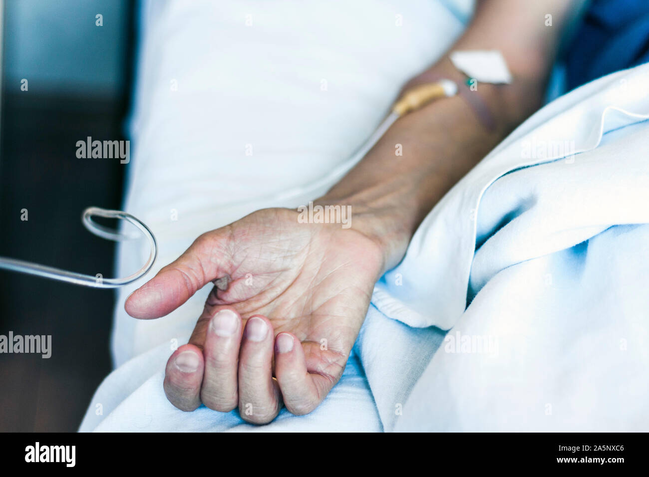 Hand of patient in serious condition is given a medicine through a ...