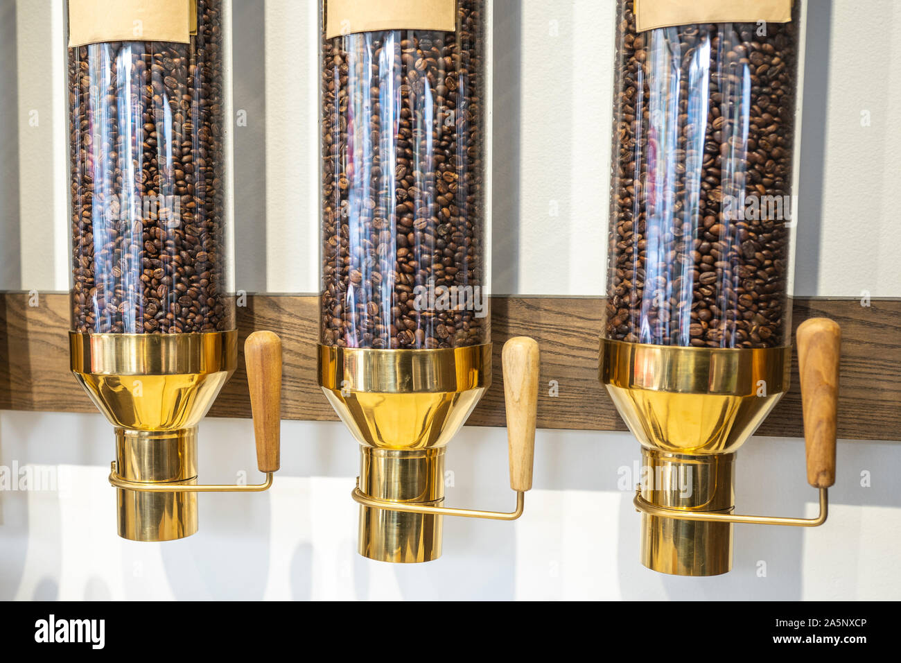 Three luxury coffee bean dispenser in coffeeshop Stock Photo - Alamy
