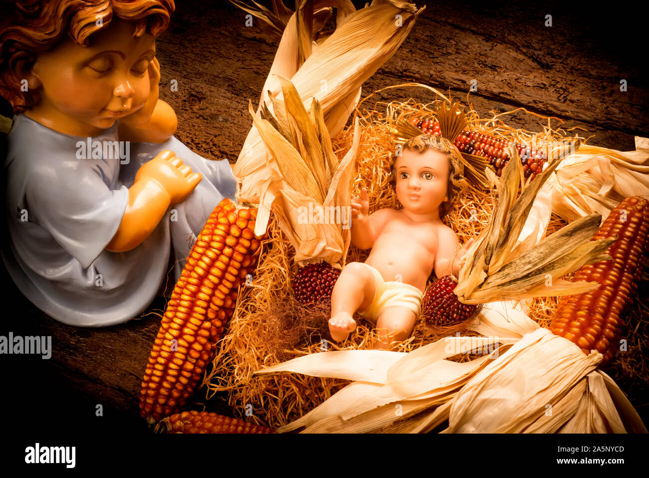 Christmas cards. Baby Jesus care by an angel in a crib made from corn ...