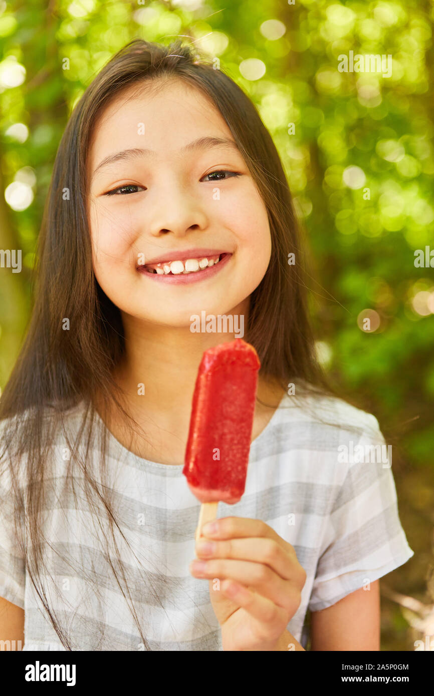 Asian girl eats a popsicle in summer as a refreshment Stock Photo - Alamy