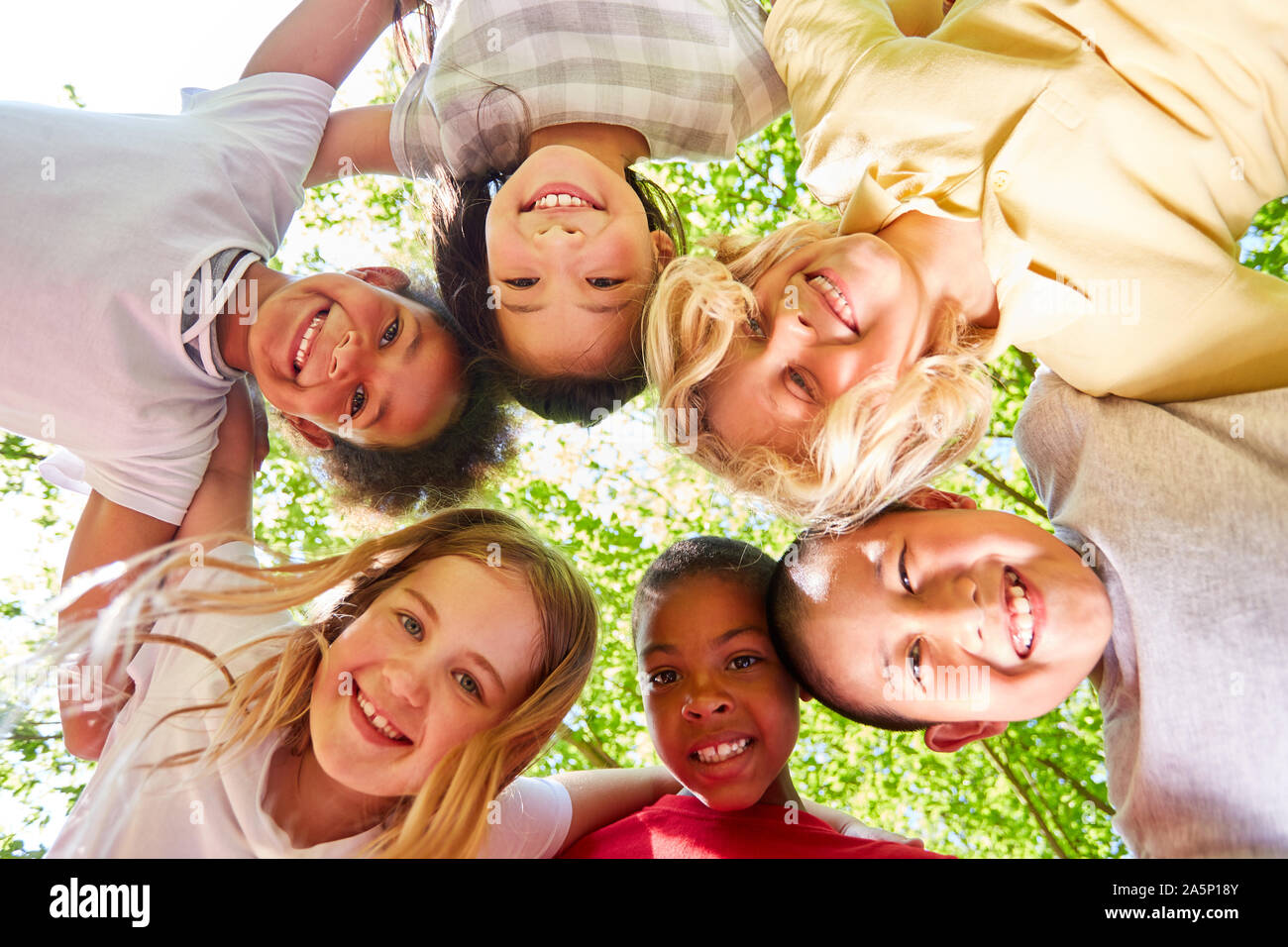 Multicultural children group in circle for friendship and diversity ...