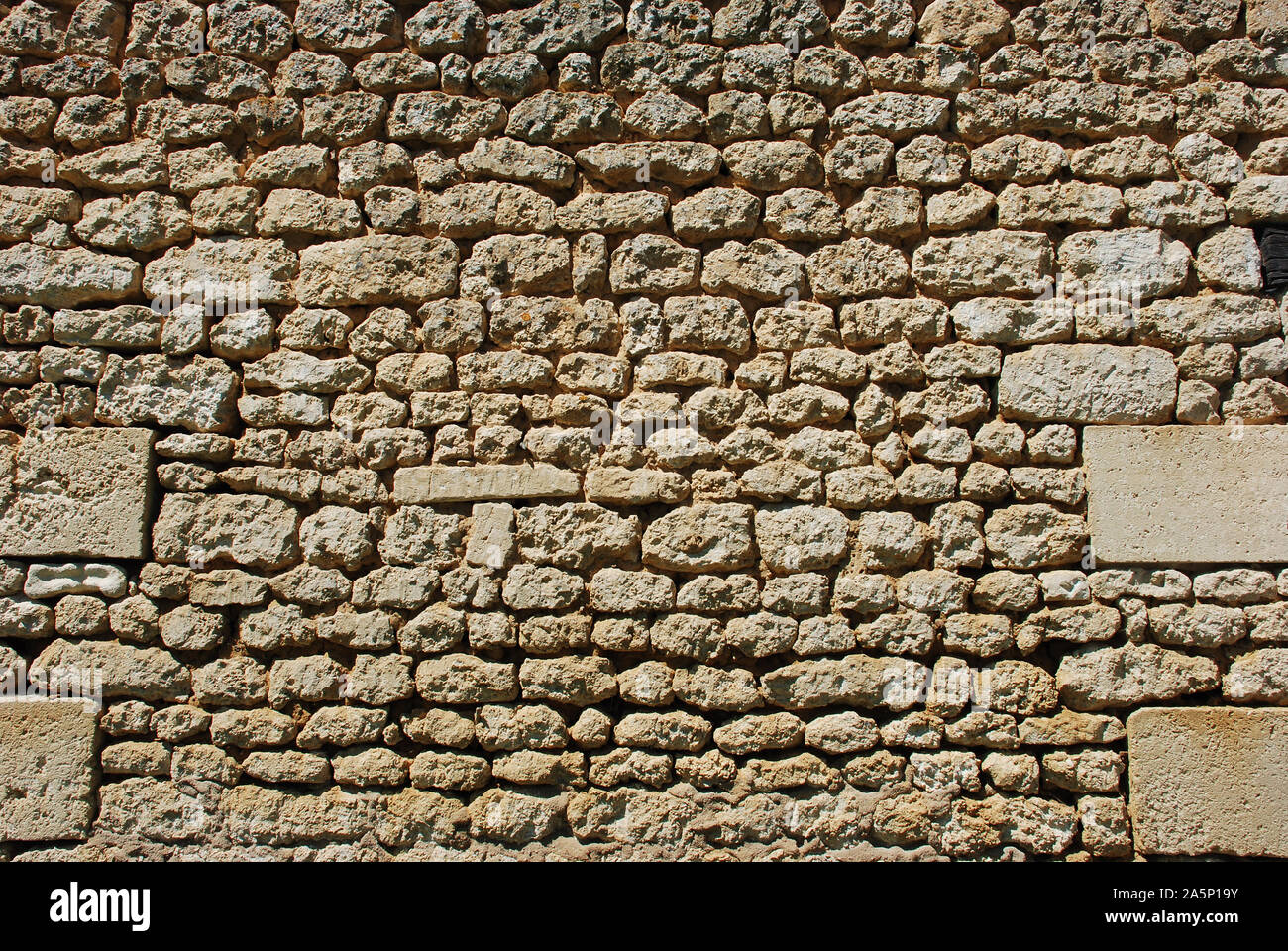 Solid wall made of stone Stock Photo - Alamy