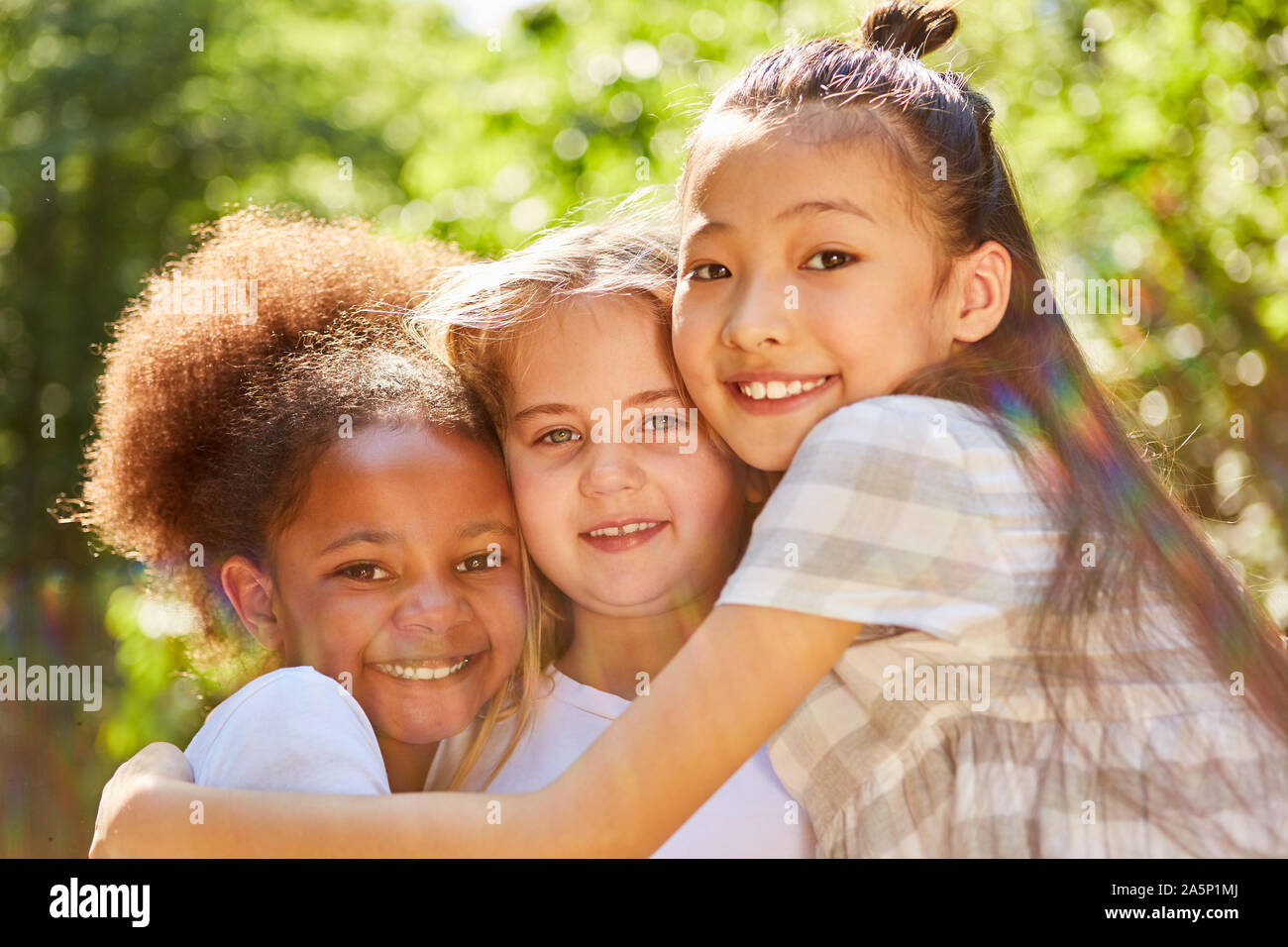 Three multicultural girls as girlfriends in nature Stock Photo - Alamy