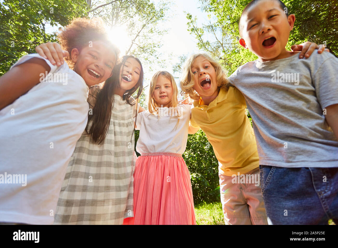 Multicultural kids have fun together as a team in summer camp Stock ...