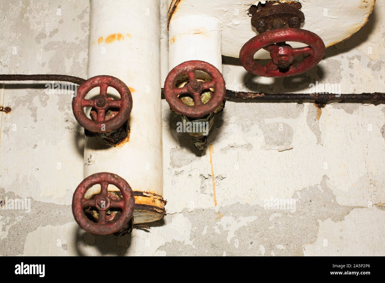 Valves and pipes on wall Stock Photo - Alamy