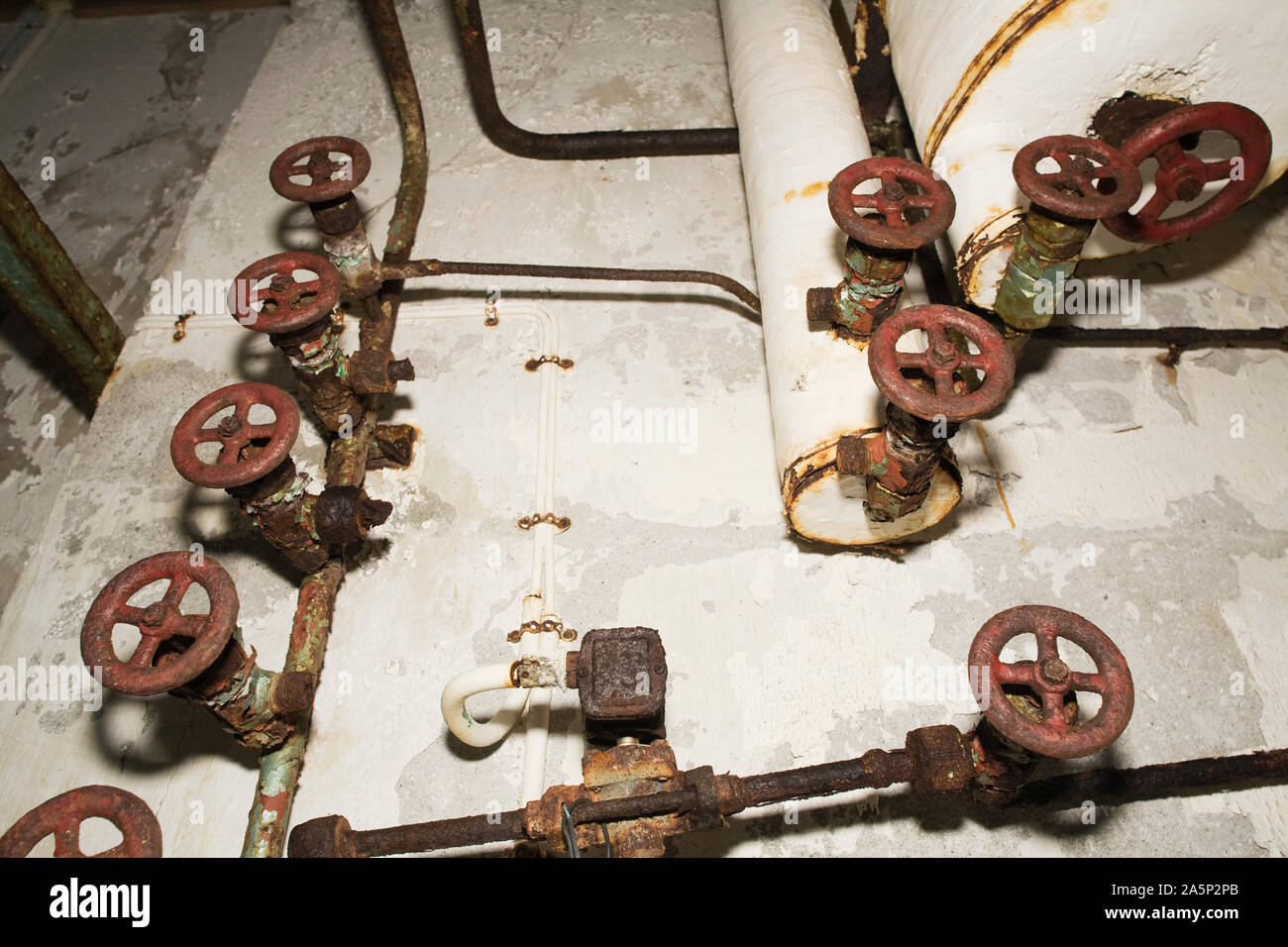 Valves and pipes on wall Stock Photo - Alamy