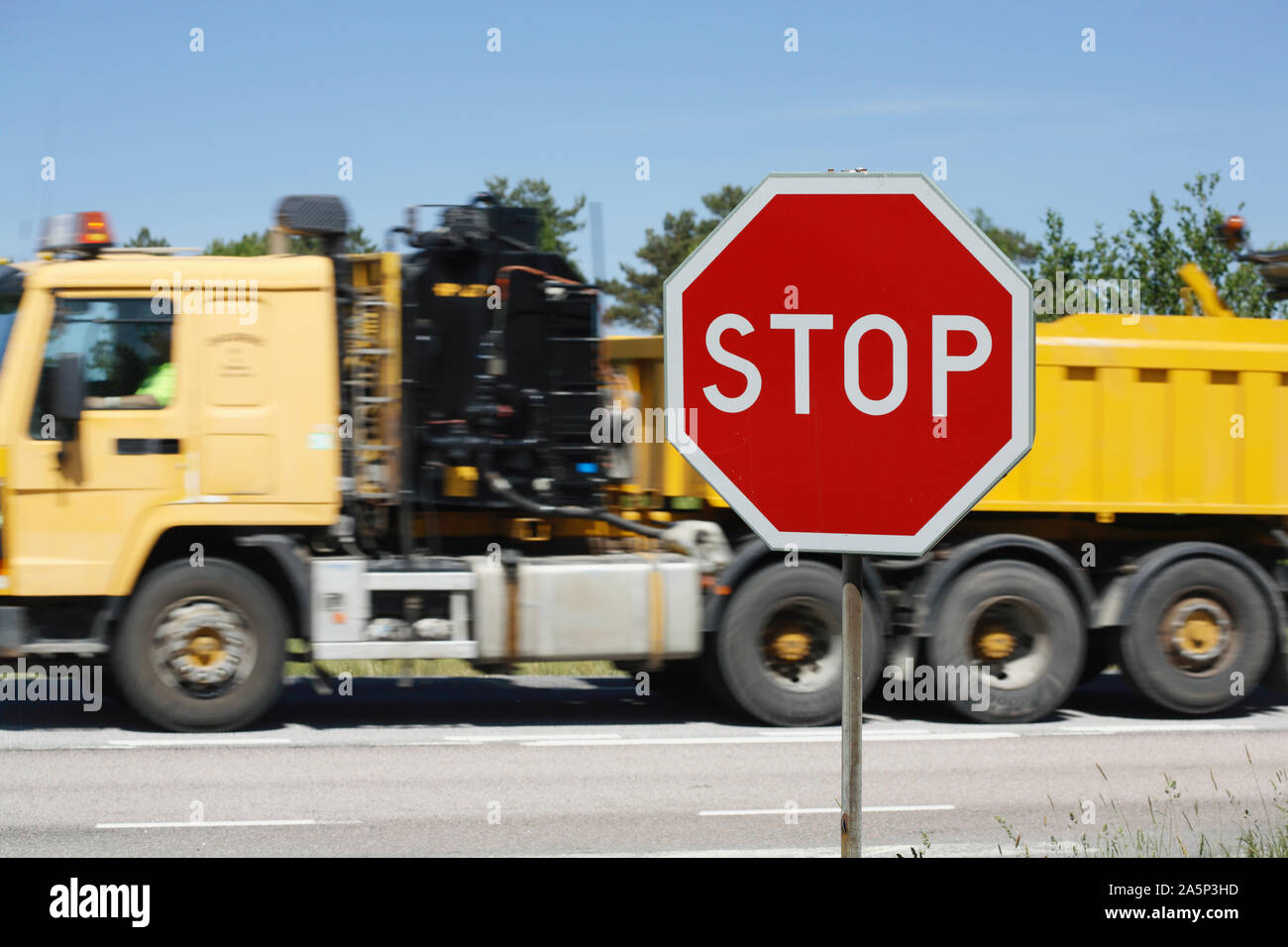 Stop sign with truck in background Stock Photo - Alamy