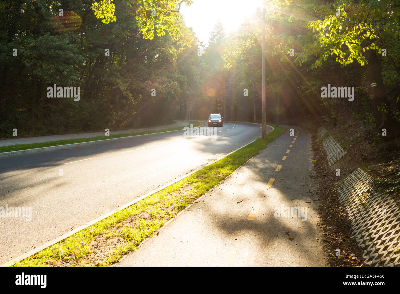 Road with a car and cycle bike lane path, Loverek, Sopron, Hungary ...