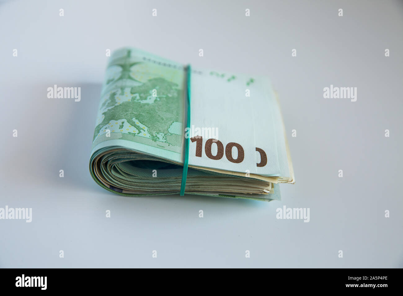 Currency tightened by an elastic band on white background Stock Photo ...