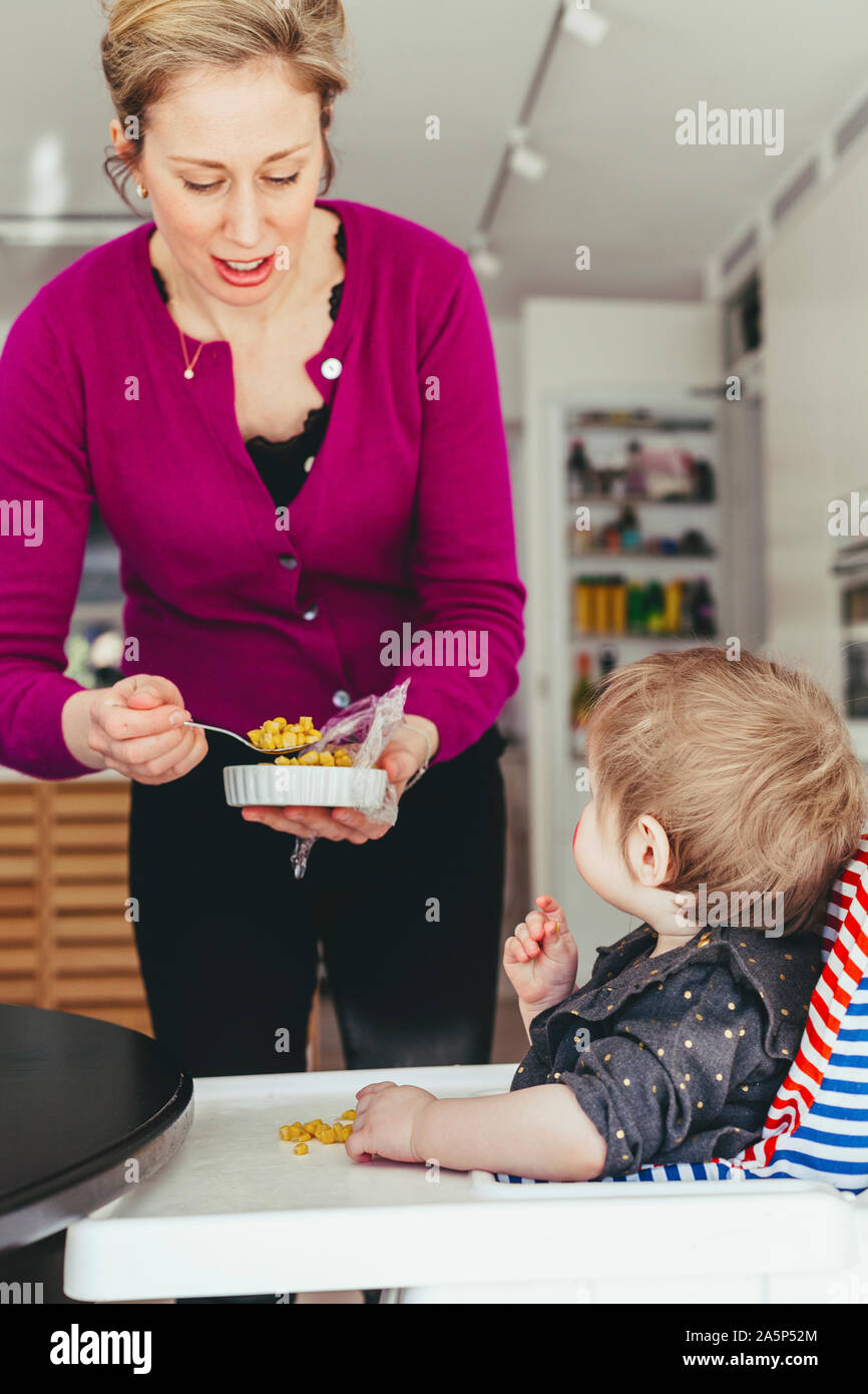 Girl on high chair Stock Photo - Alamy