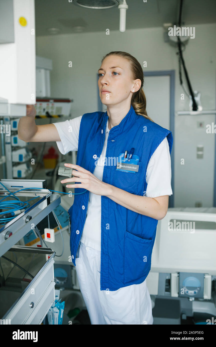 Female engineer checking hospital equipment Stock Photo - Alamy