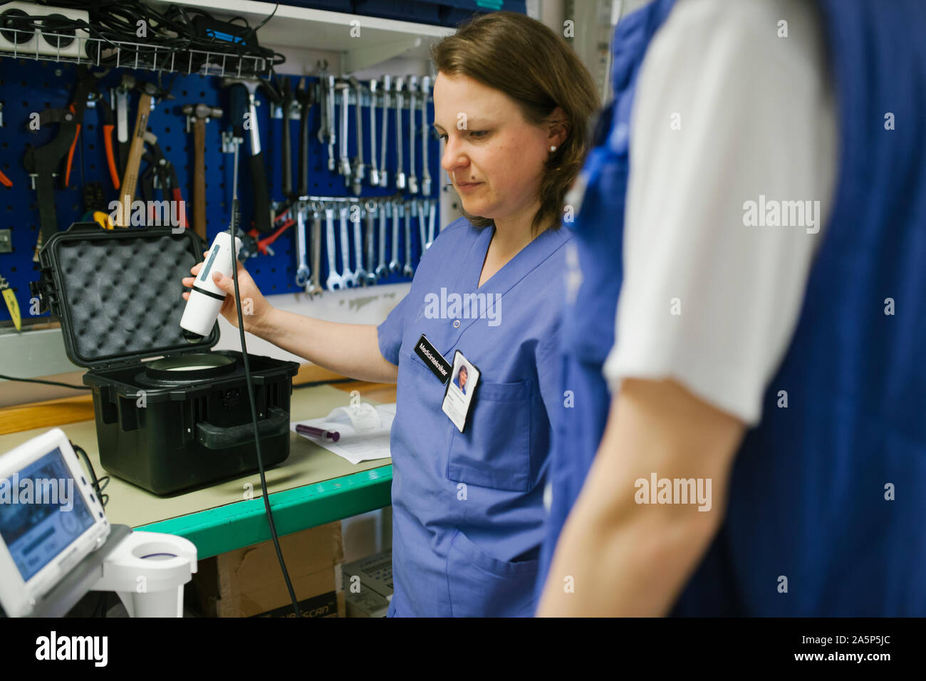 Female engineer checking hospital equipment Stock Photo - Alamy