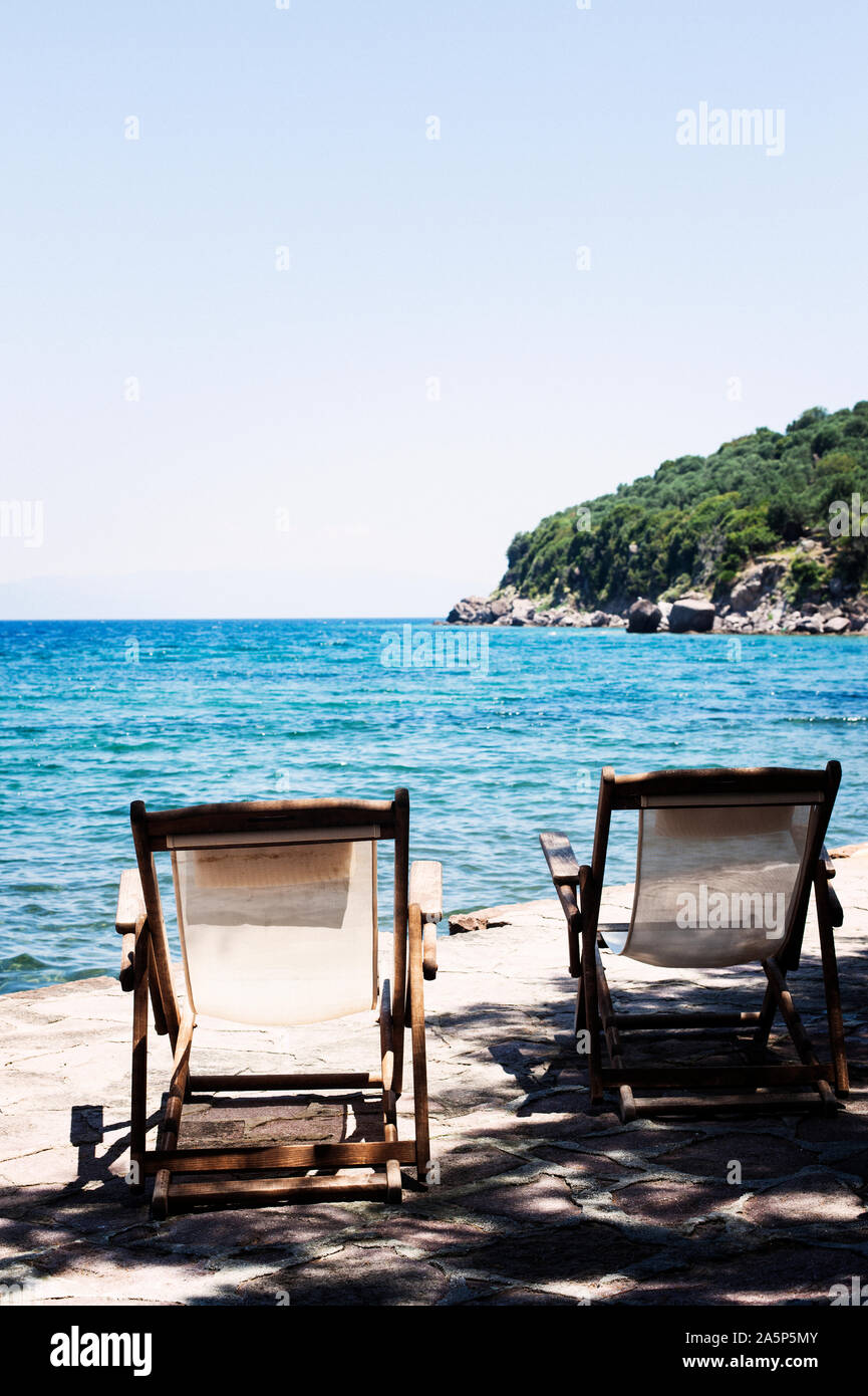 Sunchairs on sandy beach Stock Photo - Alamy