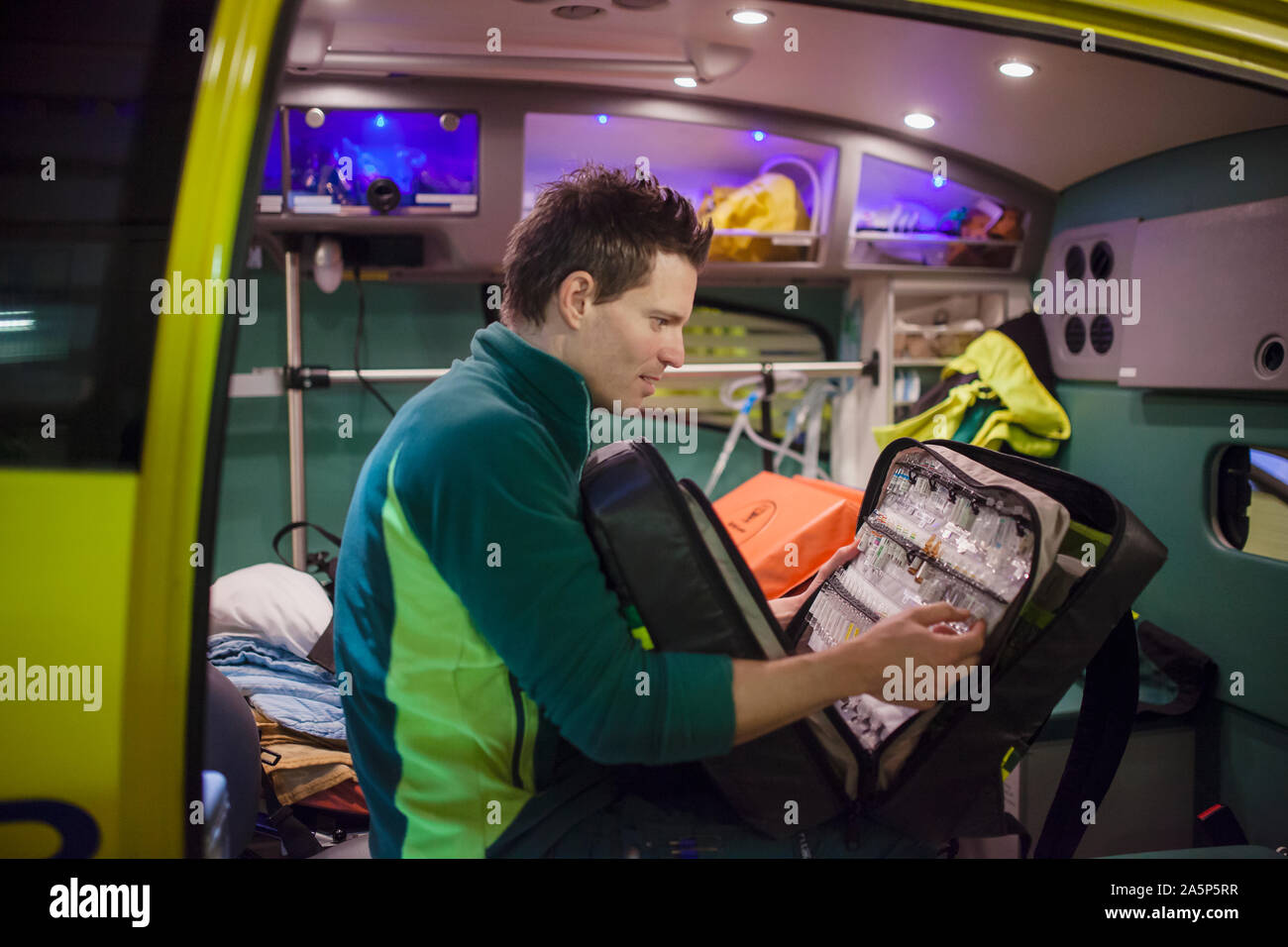Paramedic in ambulance Stock Photo - Alamy