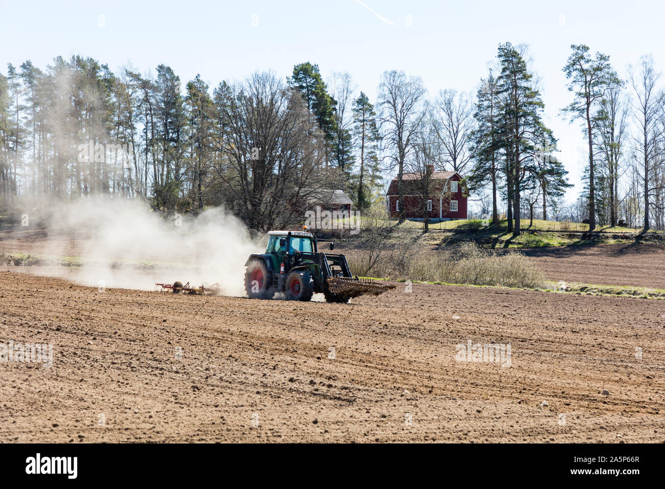 Tractor plowing field Stock Photo - Alamy