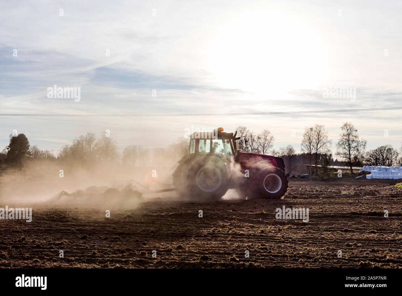 Tractor plowing field Stock Photo - Alamy
