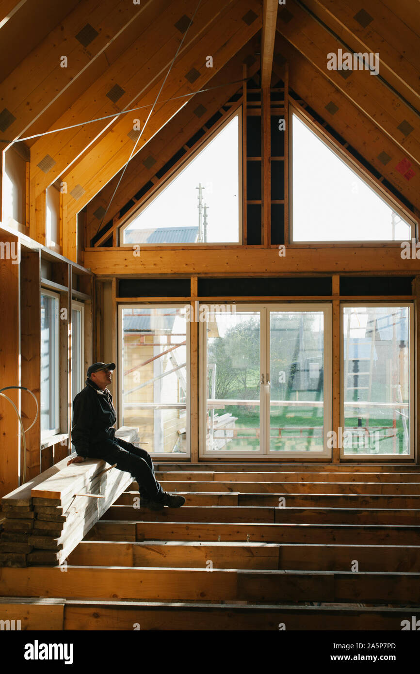 Man inside house under construction Stock Photo - Alamy
