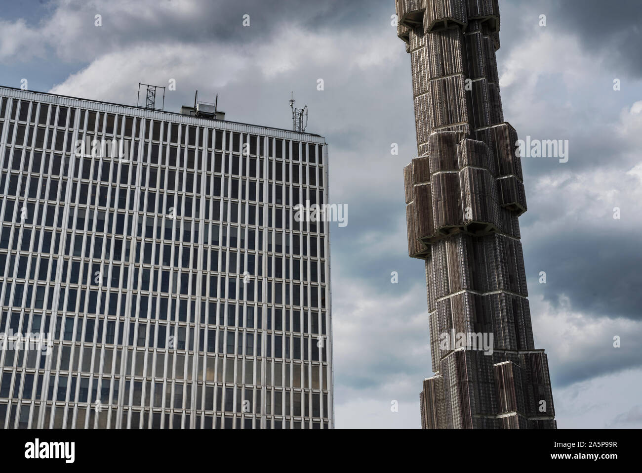 Concrete structure near skyscraper Stock Photo - Alamy