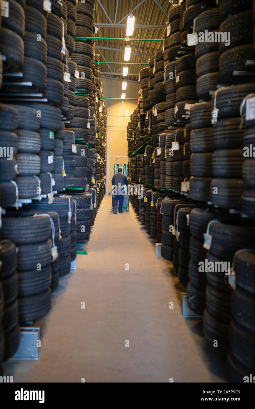 Stacks of tires in warehouse Stock Photo - Alamy