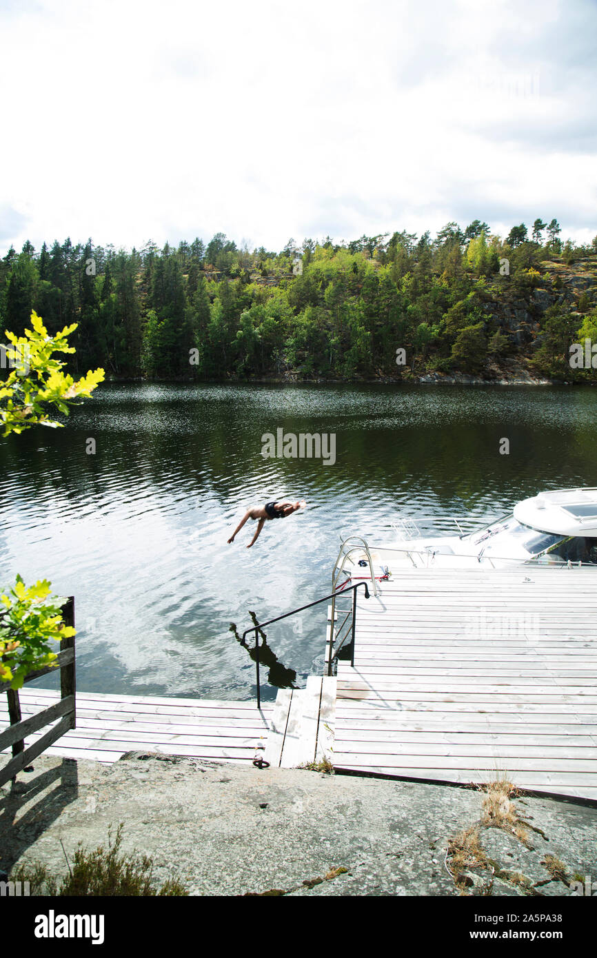 Man jumping into water hi-res stock photography and images - Alamy