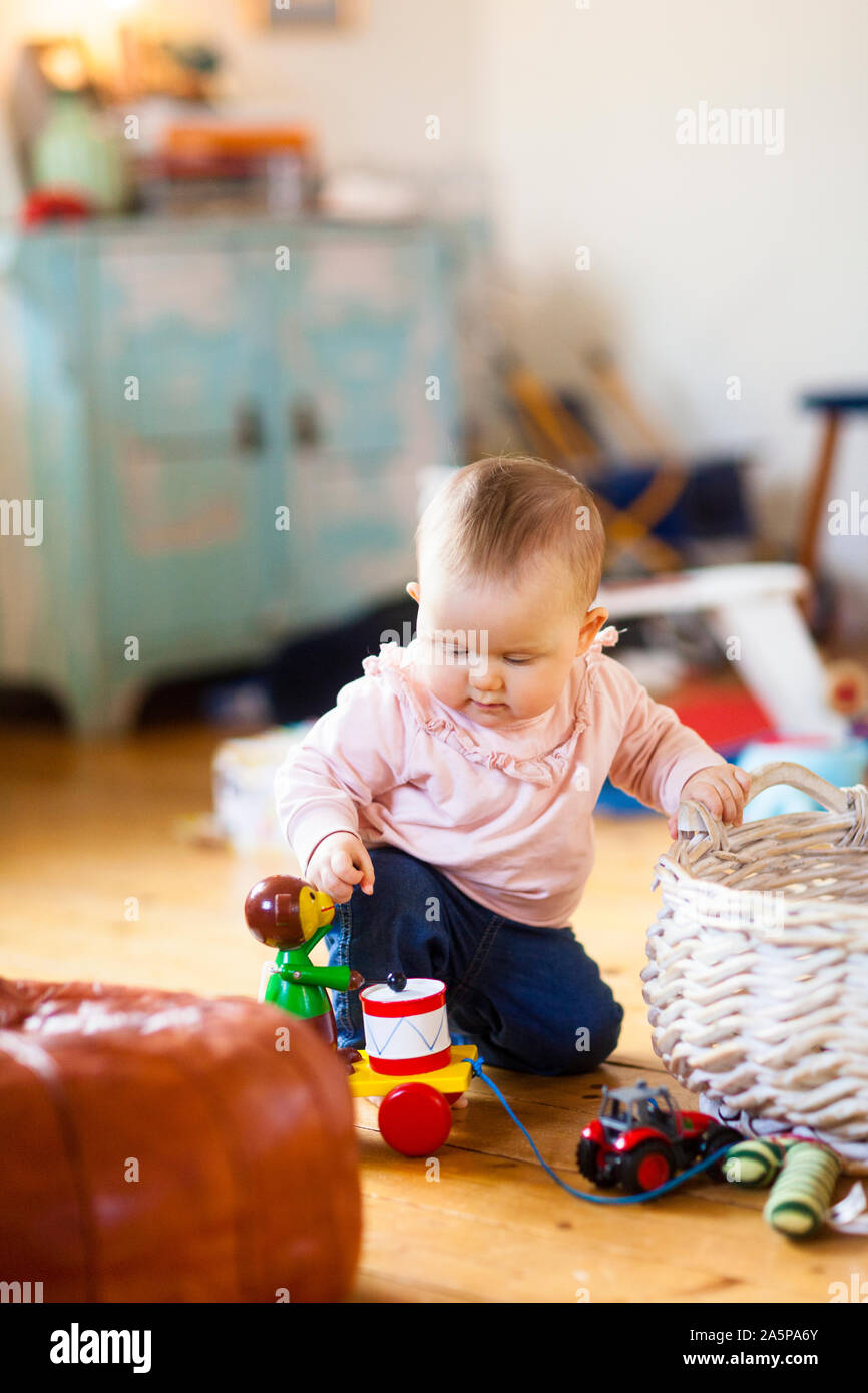 Baby girl playing Stock Photo - Alamy