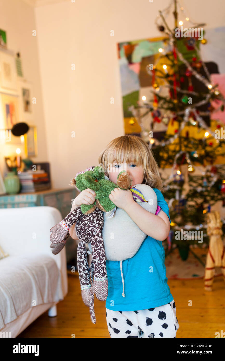 Girl carrying toys Stock Photo - Alamy