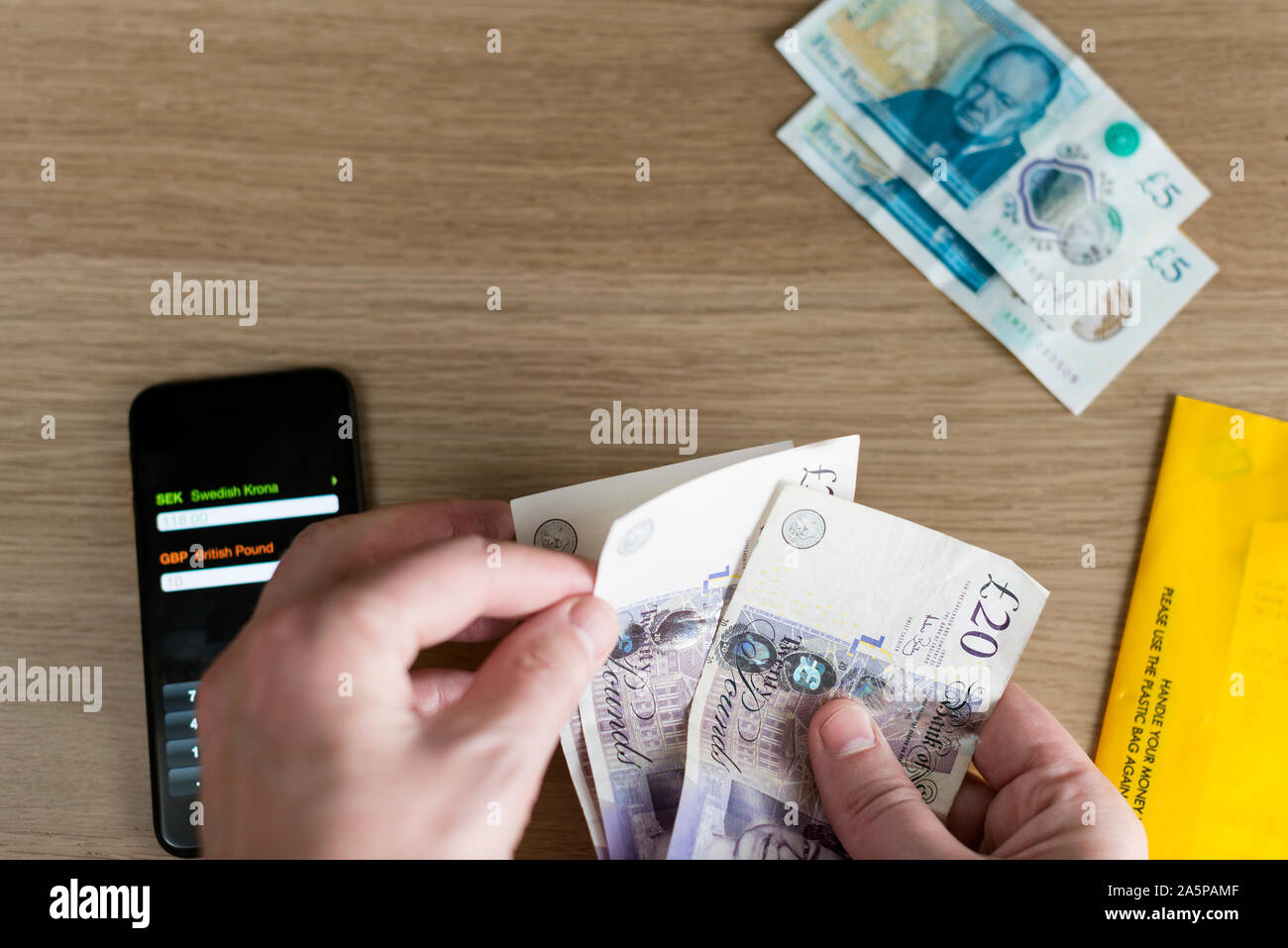 Hands counting British pounds Stock Photo - Alamy