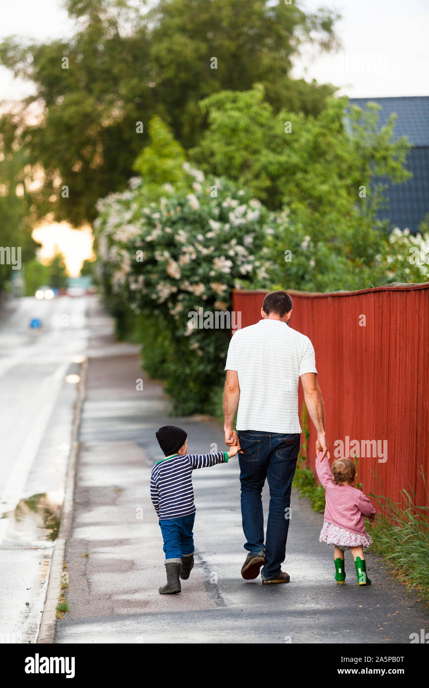 Father walking with kids Stock Photo - Alamy