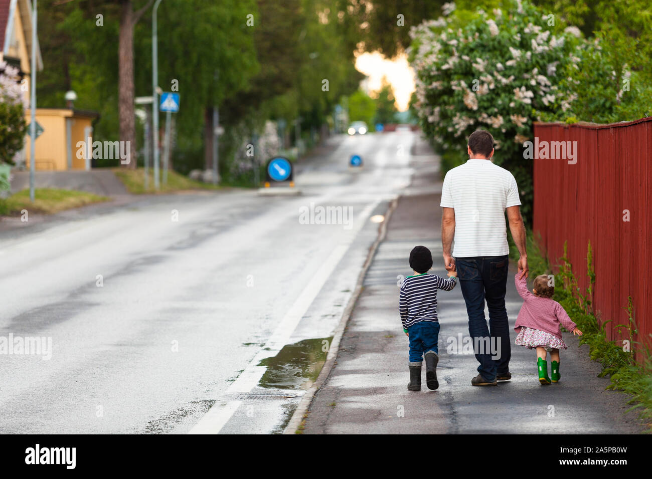 Father walking with kids Stock Photo - Alamy