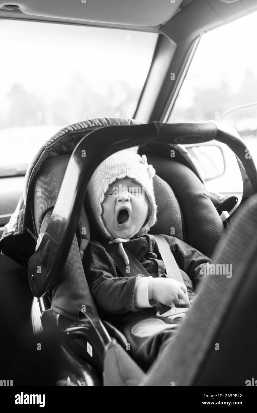 Baby in car yawning Stock Photo - Alamy