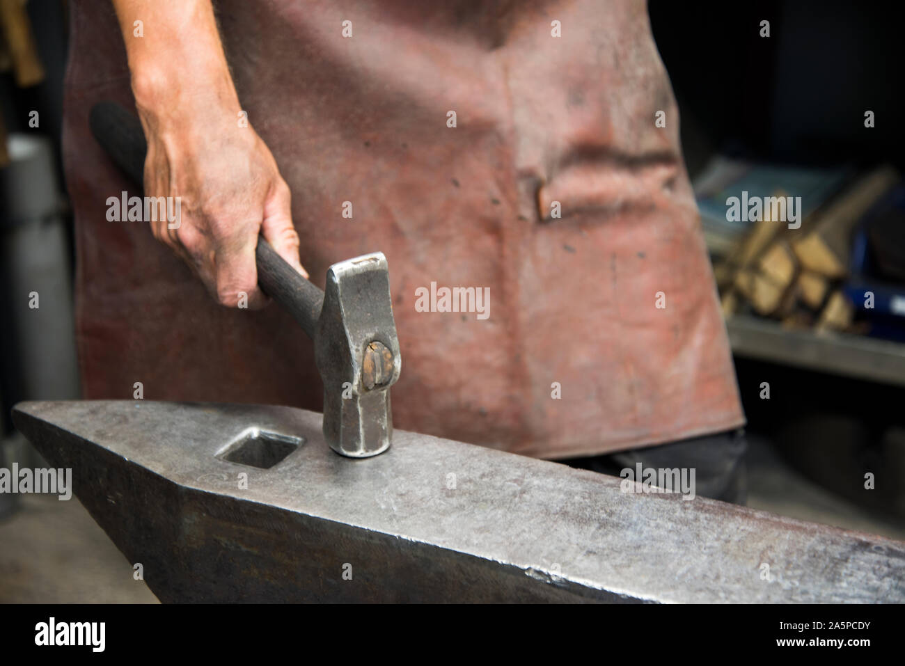 Man working in black smithery Stock Photo - Alamy