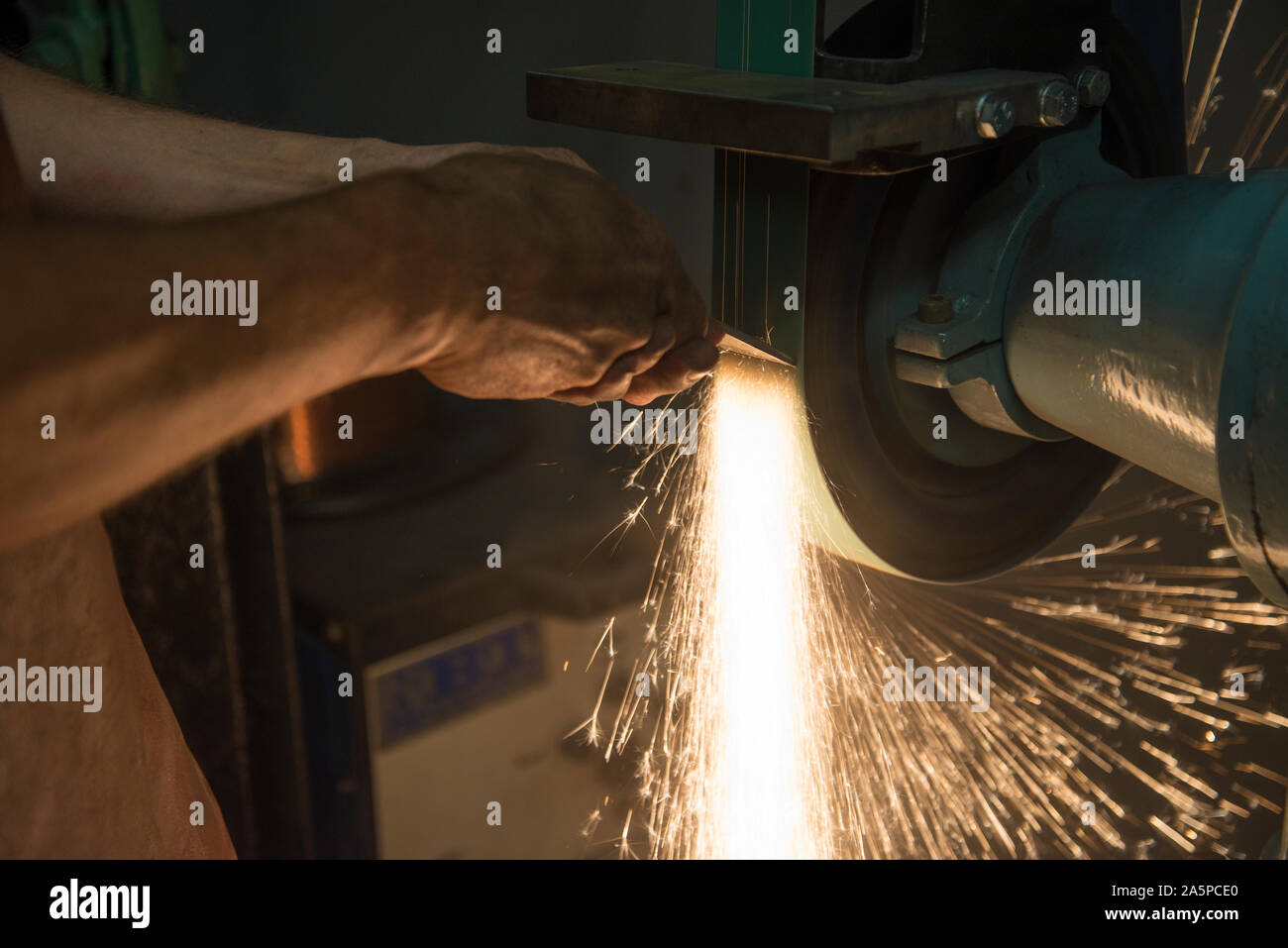 Man working on grinder Stock Photo - Alamy