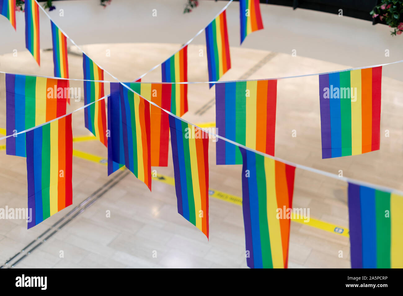 Rainbow flags hanging on rope Stock Photo - Alamy