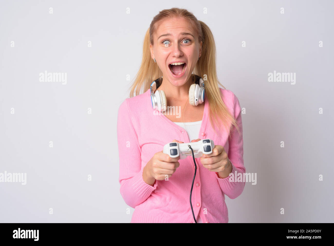 Portrait of happy young blonde nerd woman playing games and winning ...