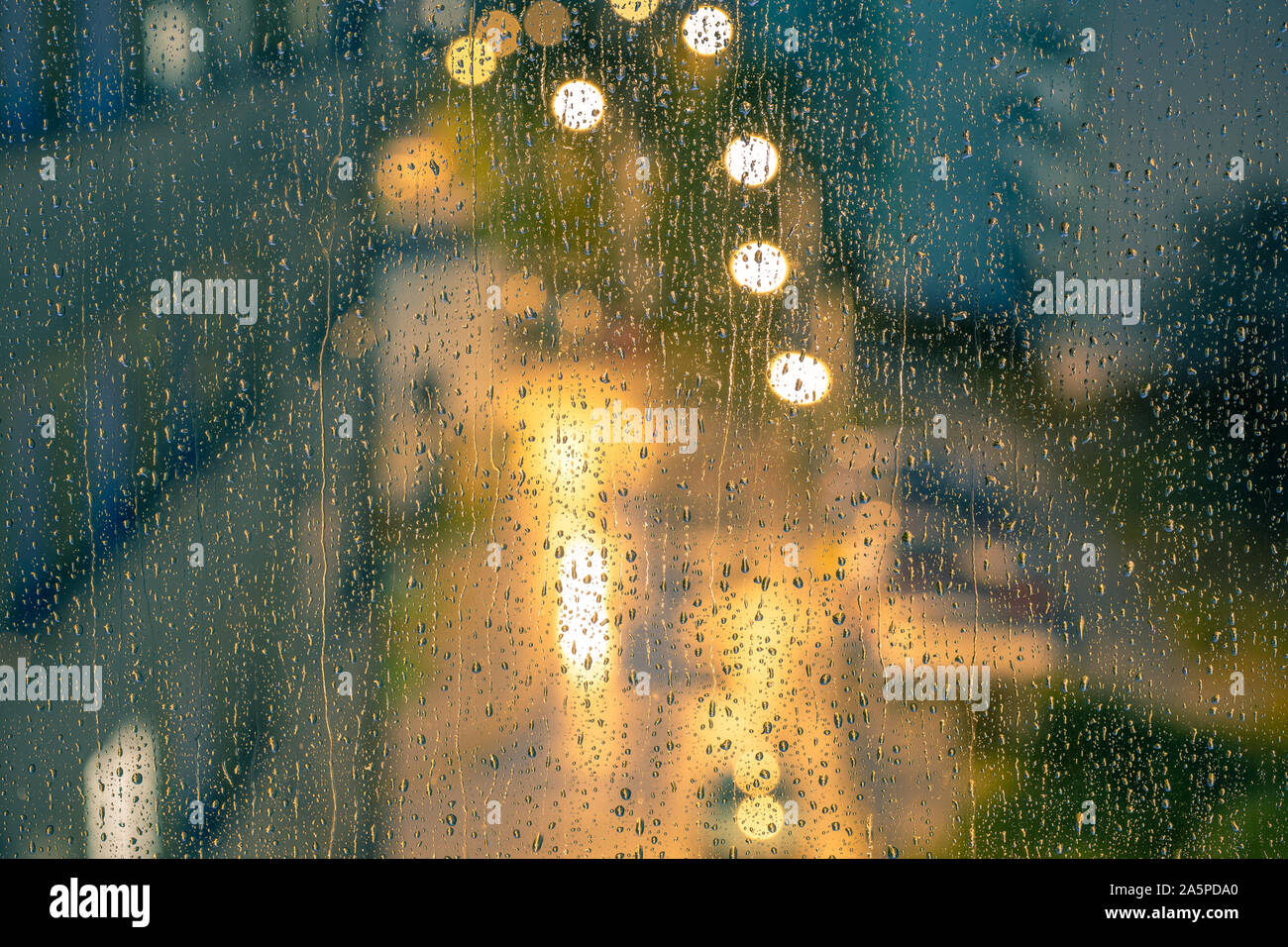 Water drops on the window pane, glass. Lights of the city. Bokeh ...