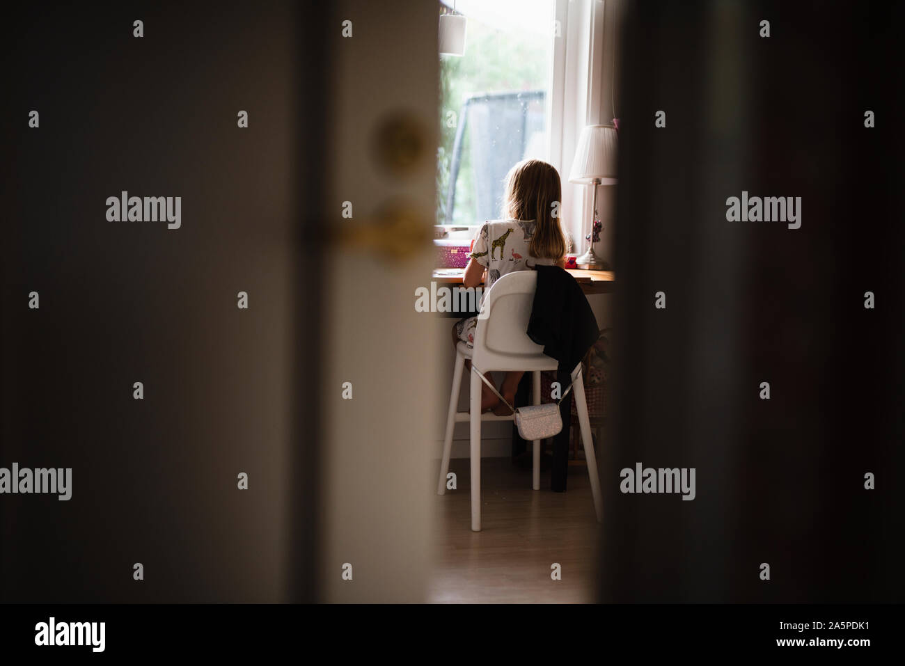 Girl sitting on chair, rear hi-res stock photography and images - Alamy