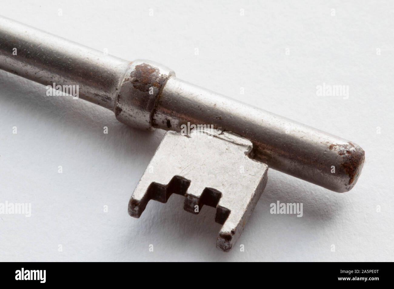 metal key on a white background Stock Photo - Alamy