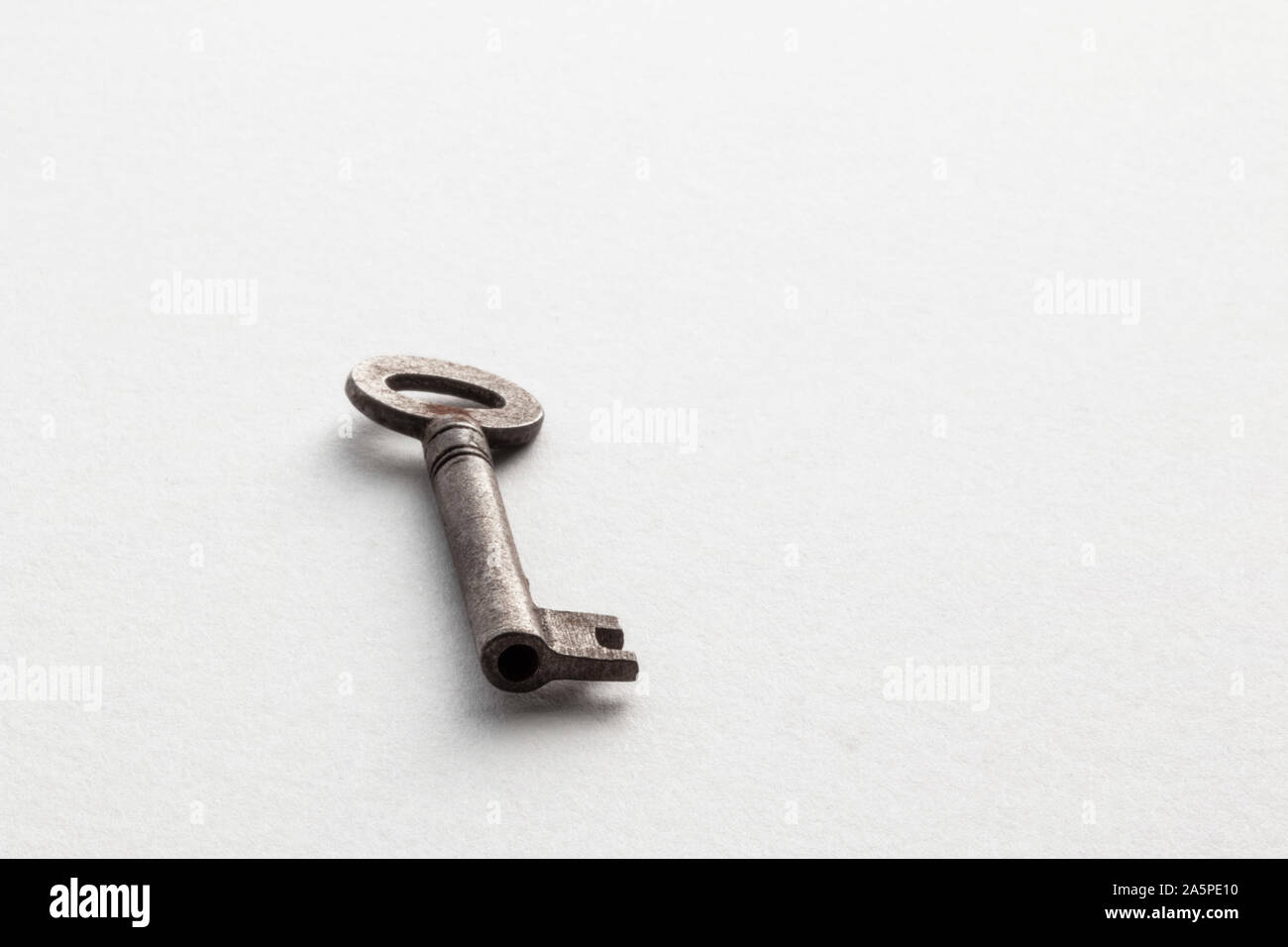 metal key on a white background Stock Photo - Alamy