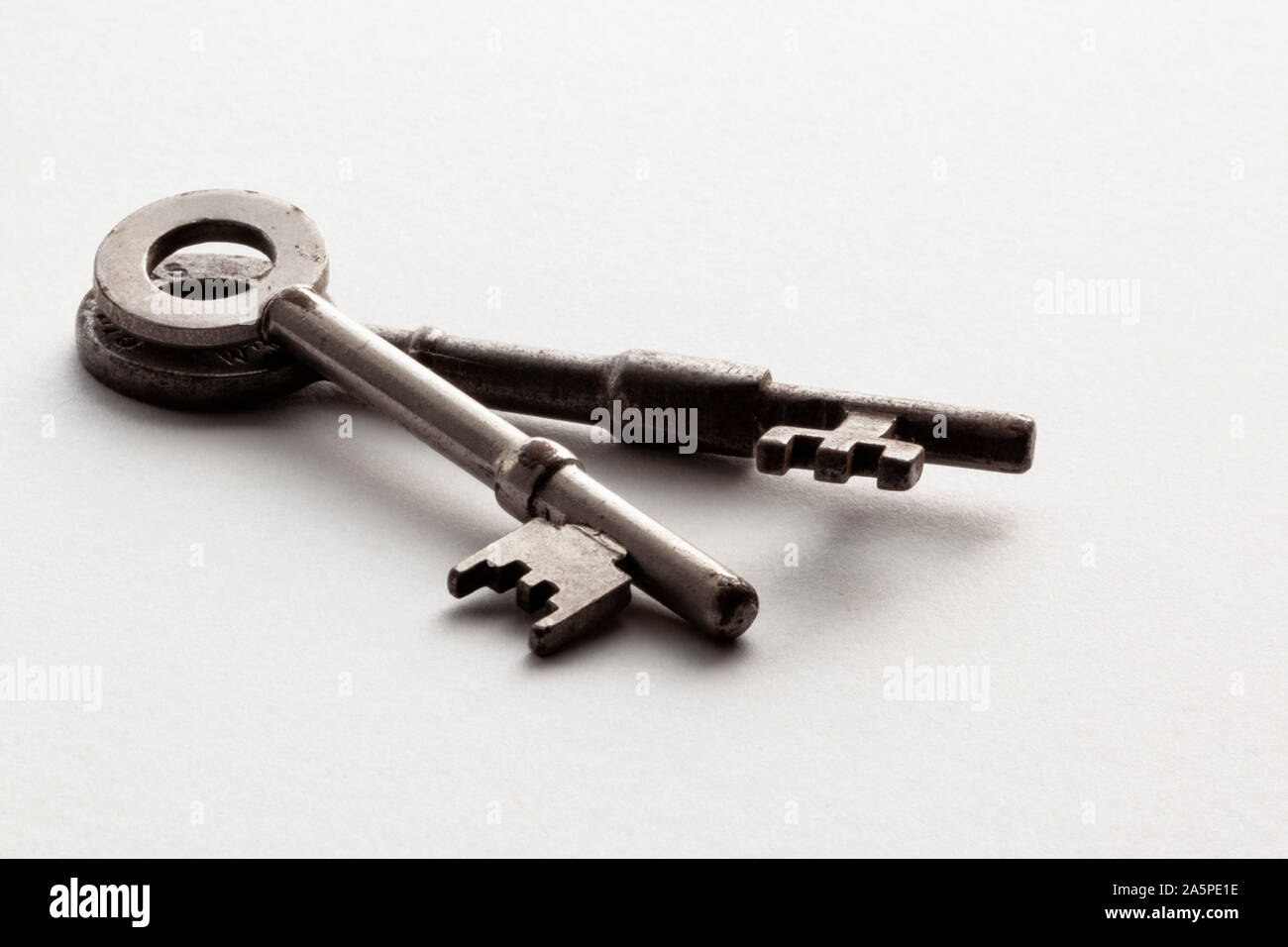metal key on a white background Stock Photo - Alamy