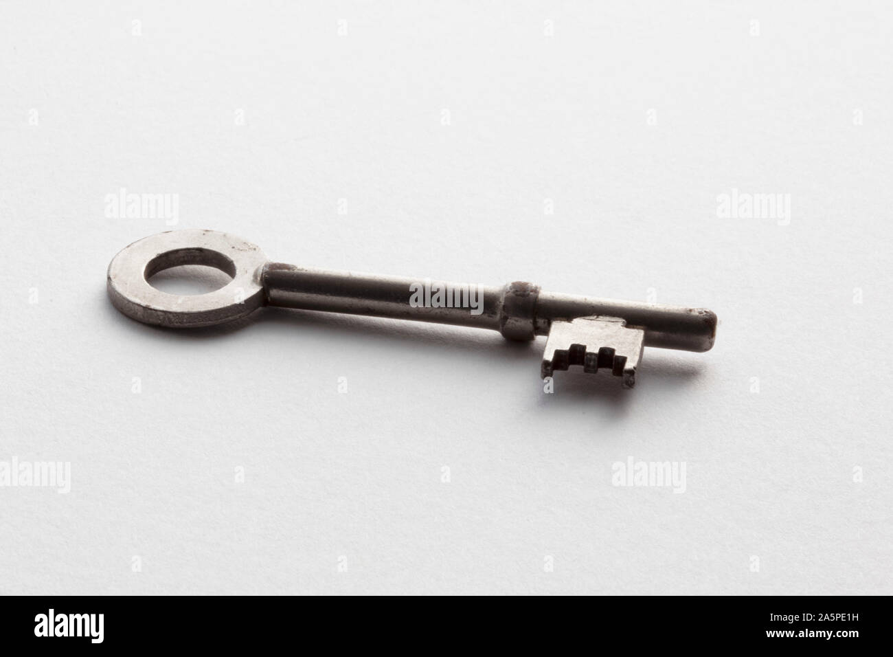 metal key on a white background Stock Photo - Alamy